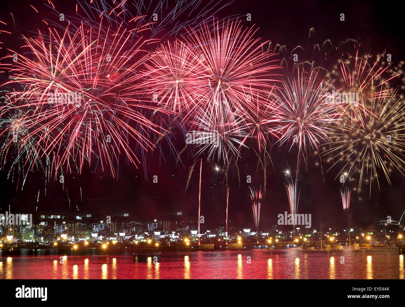 Beautiful colorful fireworks reflect on sea water Stock Photo - Alamy