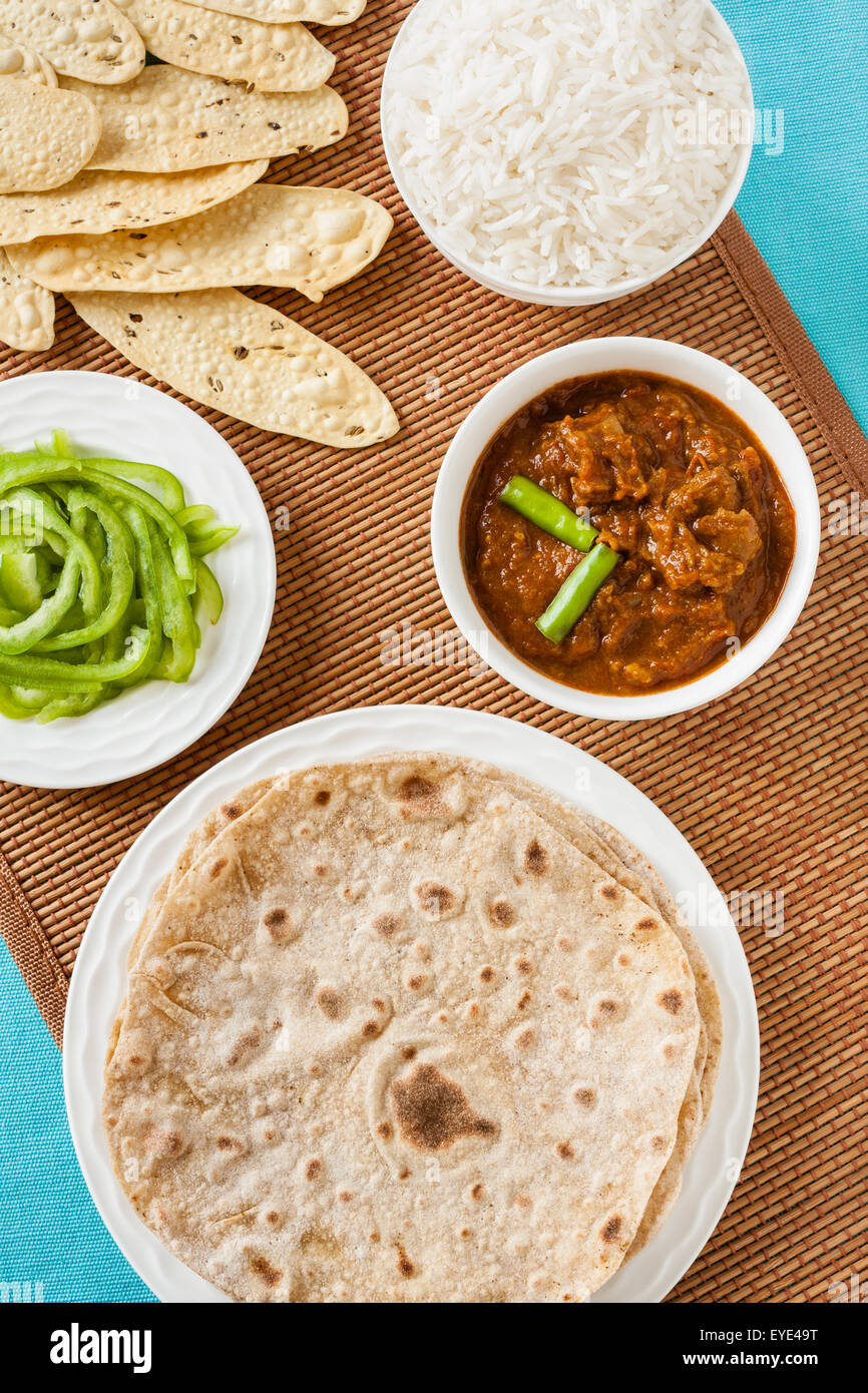 Overhead view of Indian mutton rogan josh meal with rice and chapati ...