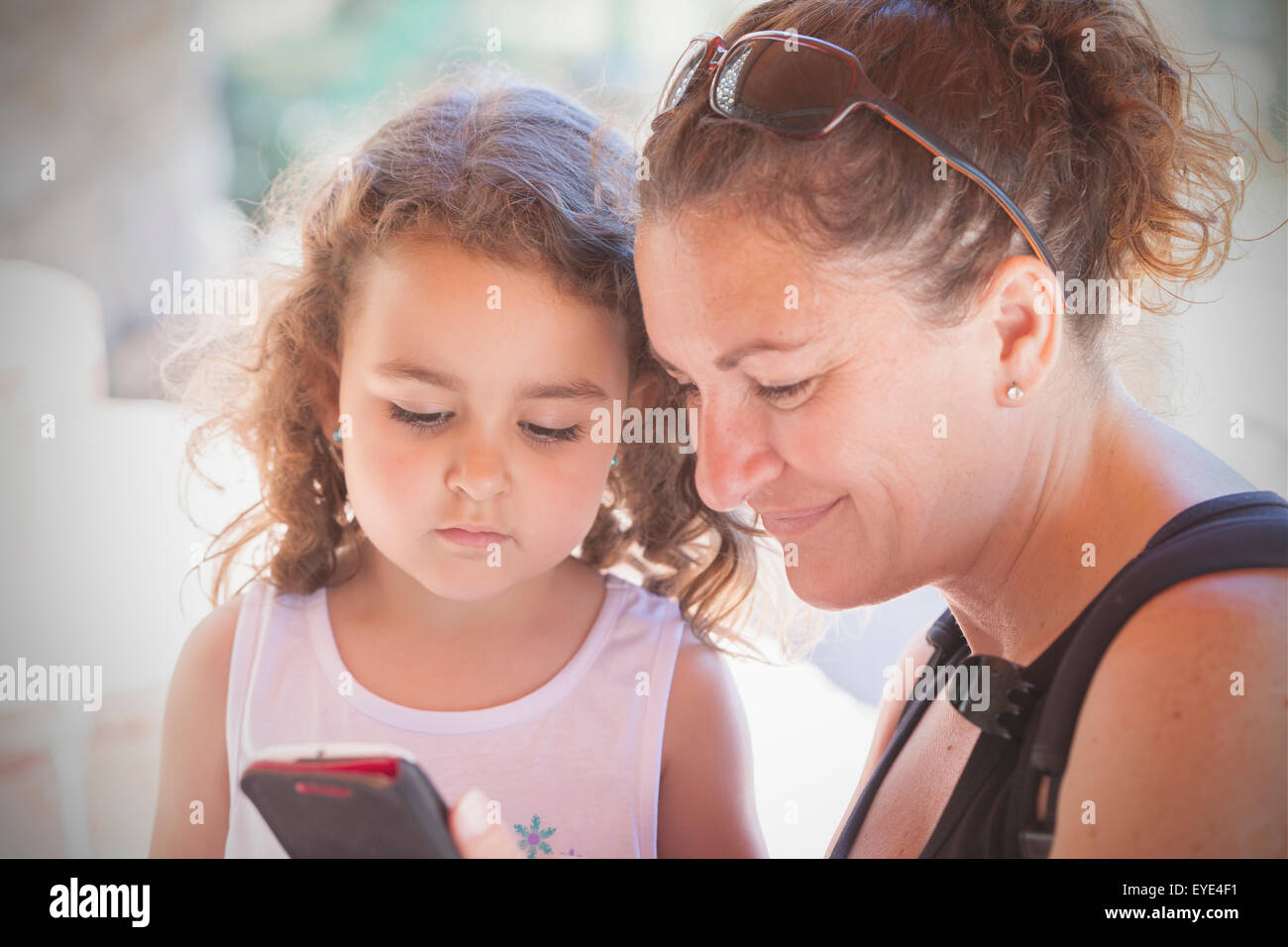 Mother and daughter looking at her phone Stock Photo - Alamy
