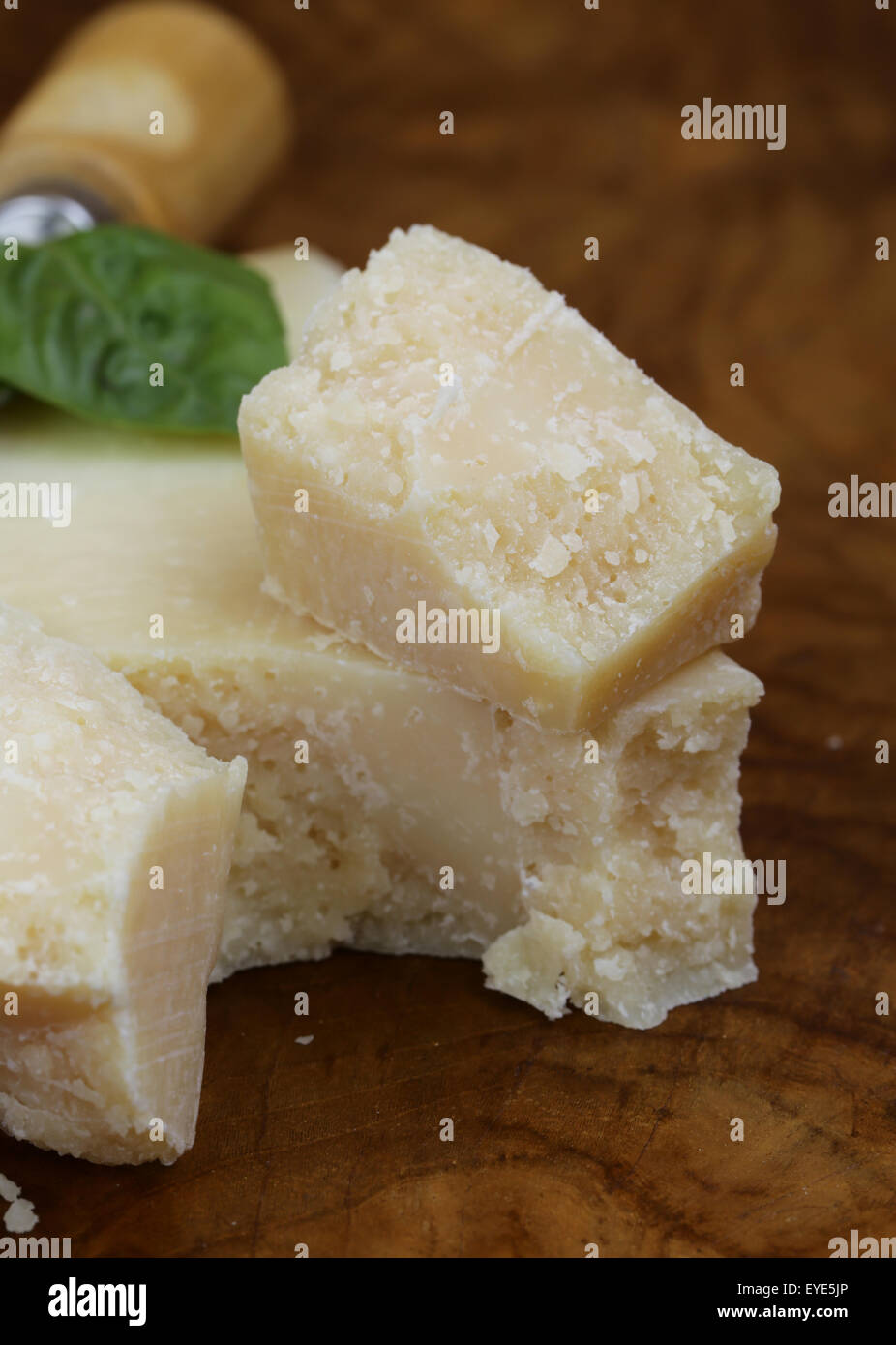 piece of natural parmesan cheese on a wooden board Stock Photo - Alamy