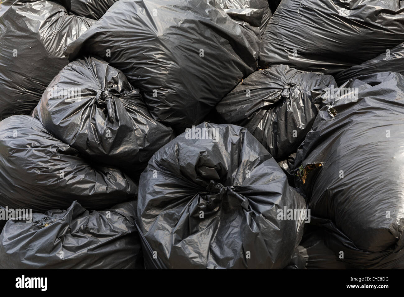 Big Stack of Black Garbage Bags Stock Photo - Alamy