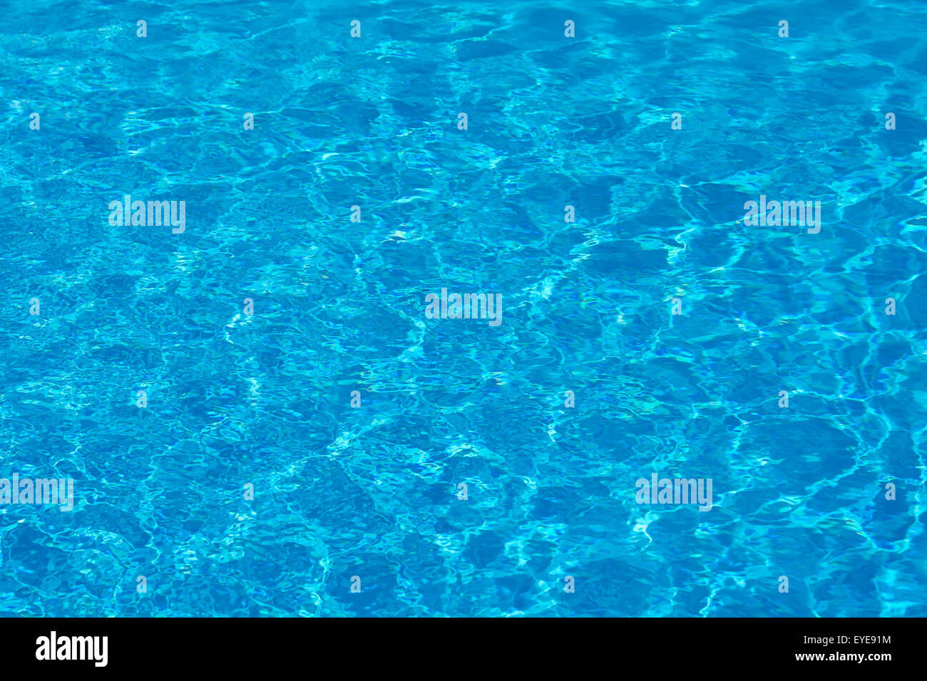 Blue pool water with sun reflections Stock Photo - Alamy