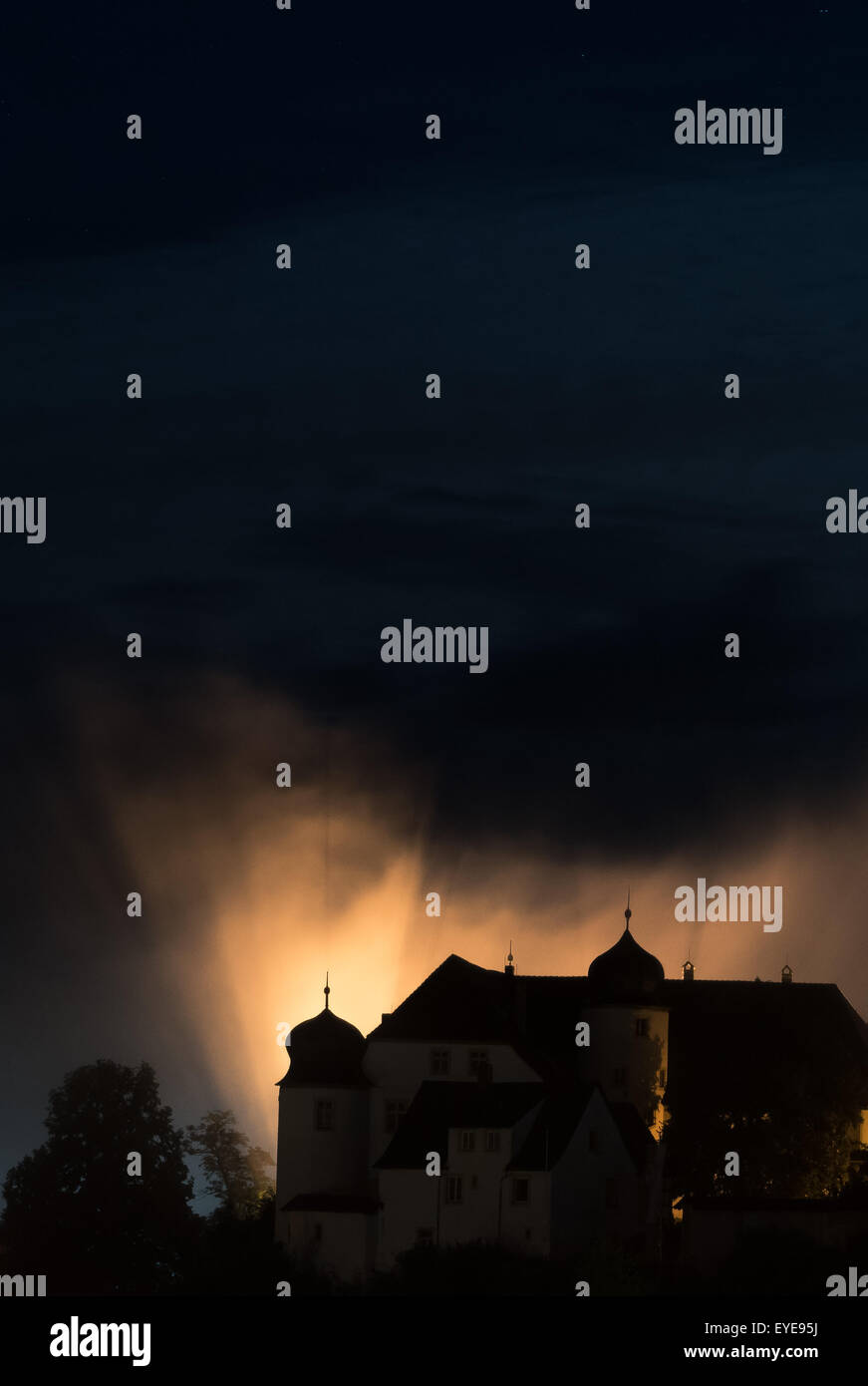 Schloss Unteraufsess castle illuminated by floodlights in thick fog in ...
