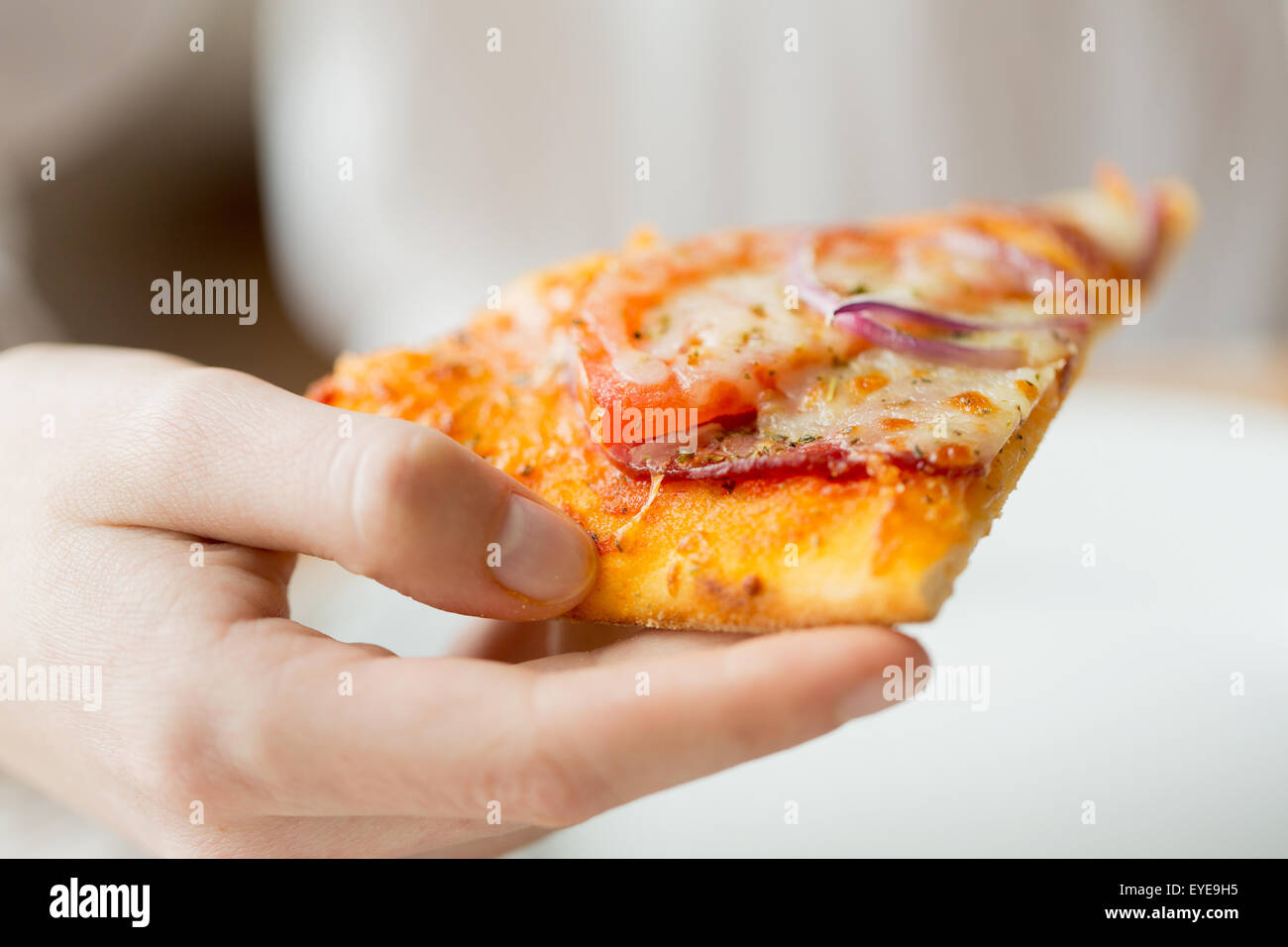Pizza slice hand hi-res stock photography and images - Alamy