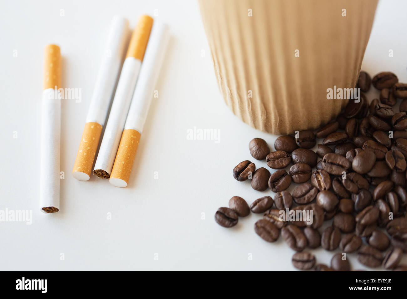 close up of cigarettes, coffee cup and beans Stock Photo - Alamy