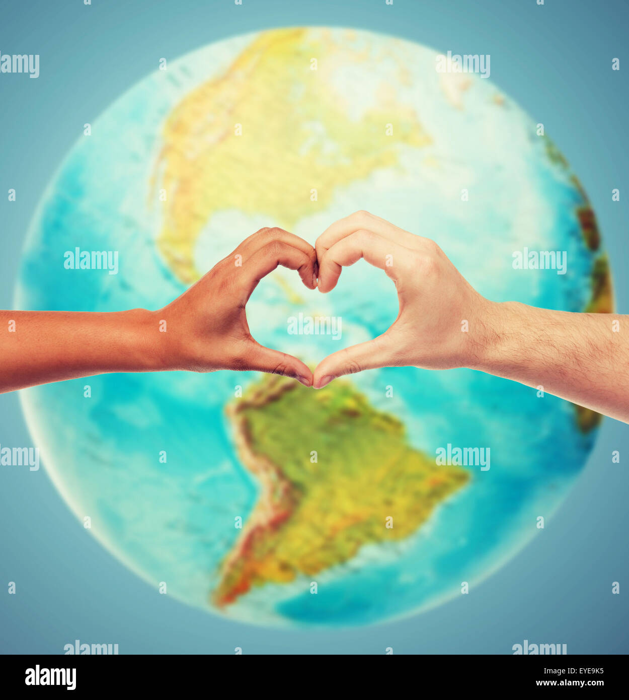 human hands showing heart shape over earth globe Stock Photo - Alamy