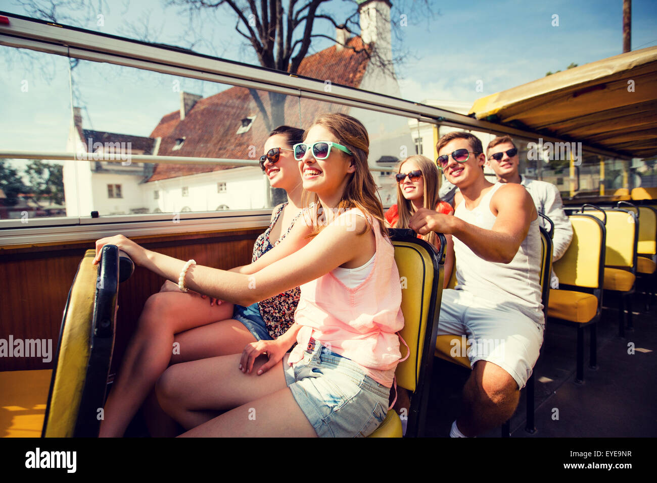 group of smiling friends traveling by tour bus Stock Photo - Alamy