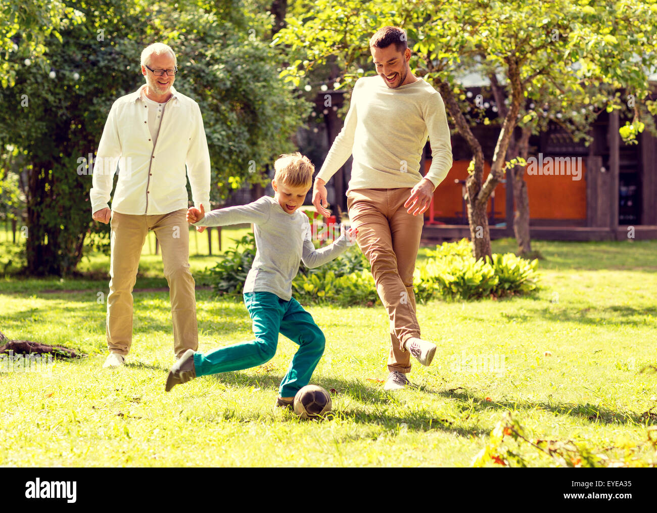 happy family playing football outdoors Stock Photo - Alamy