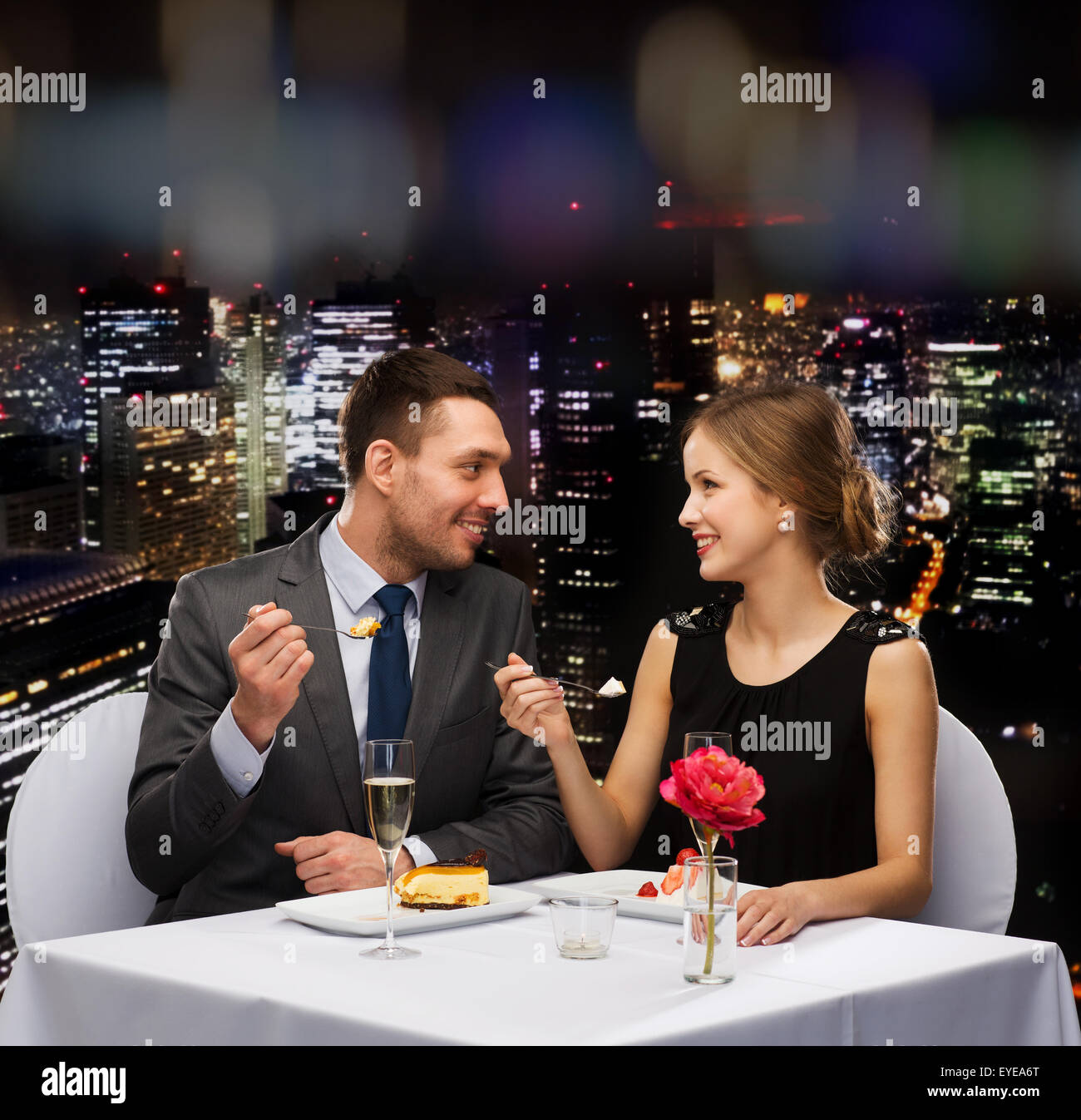 smiling couple eating dessert at restaurant Stock Photo - Alamy