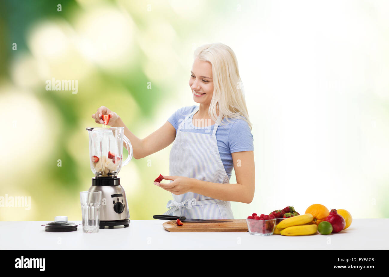 smiling woman with blender preparing shake Stock Photo - Alamy