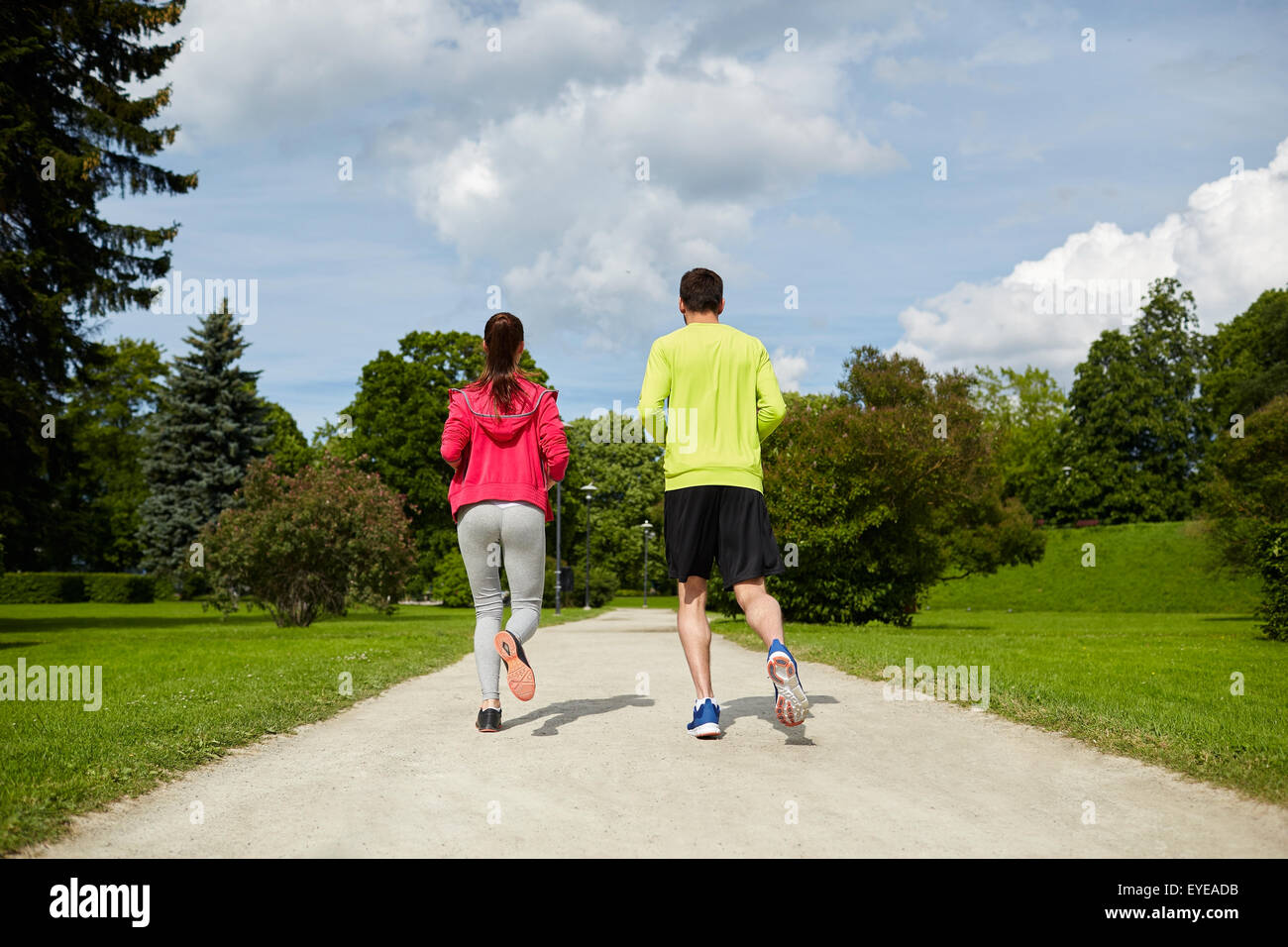 smiling couple running outdoors Stock Photo - Alamy