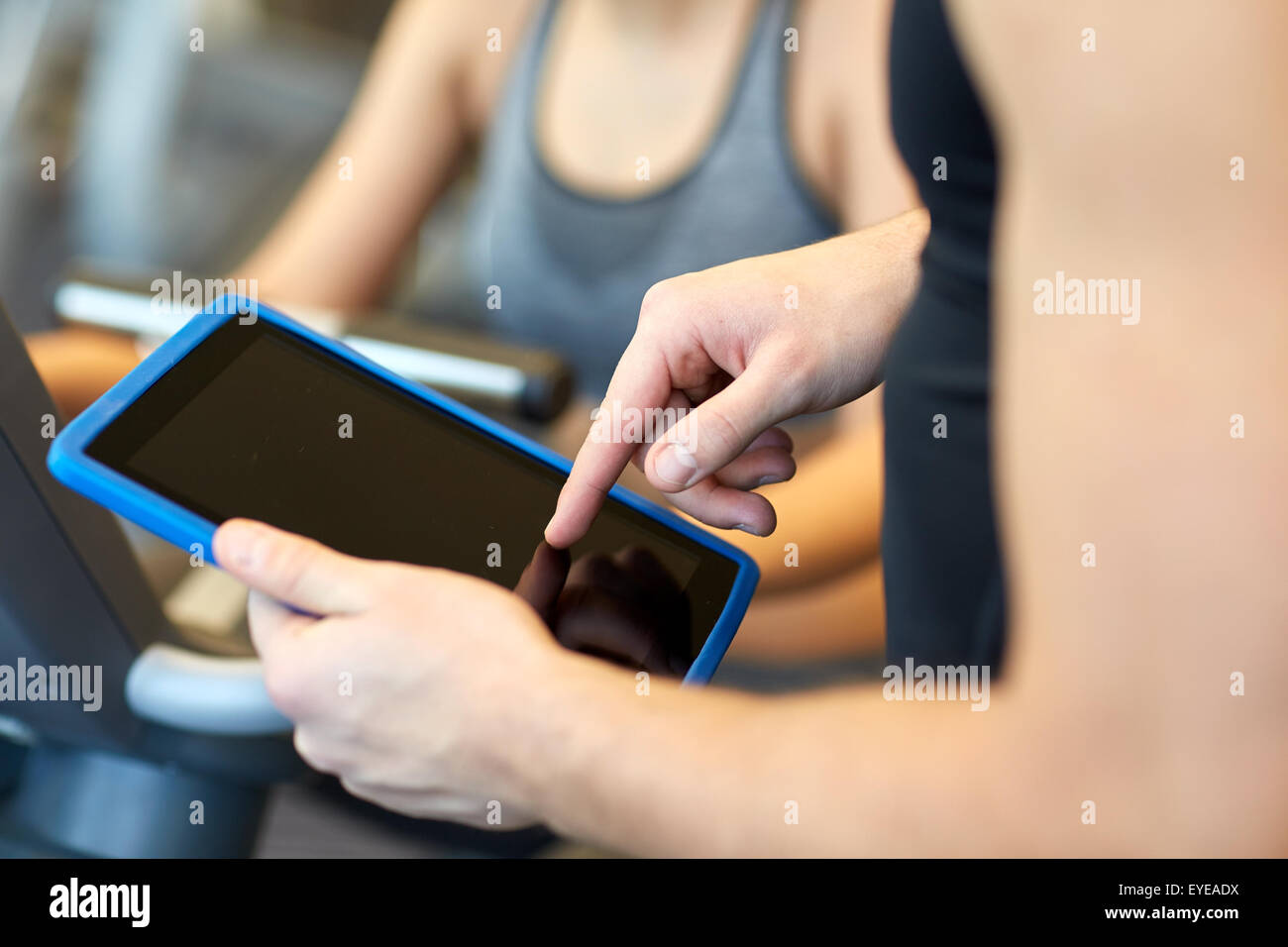 close up of trainer hands with tablet pc in gym Stock Photo - Alamy