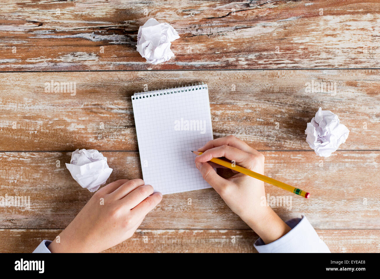 close up of hands with notebook and pencil Stock Photo - Alamy
