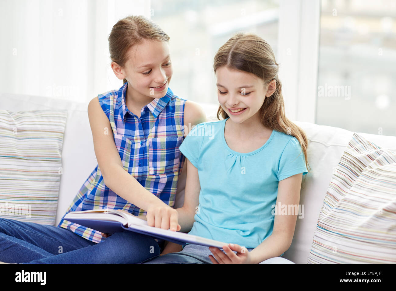 Two girls reading book hi-res stock photography and images - Alamy