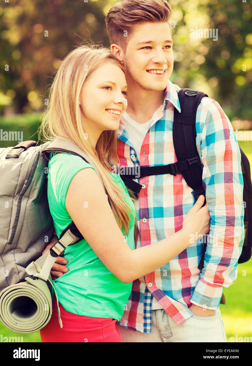 smiling couple with backpacks in nature Stock Photo - Alamy