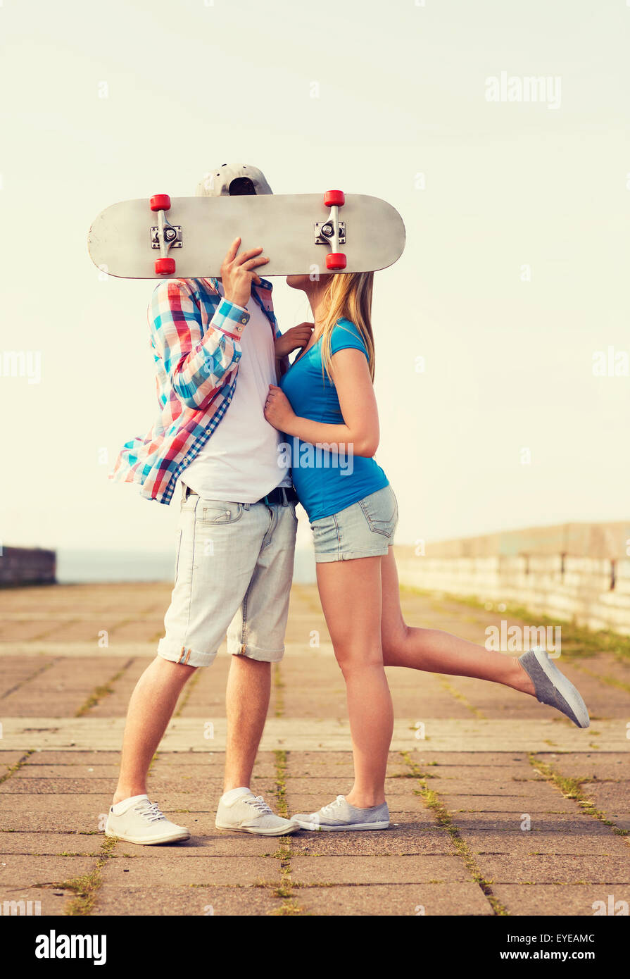 couple with skateboard kissing outdoors Stock Photo - Alamy