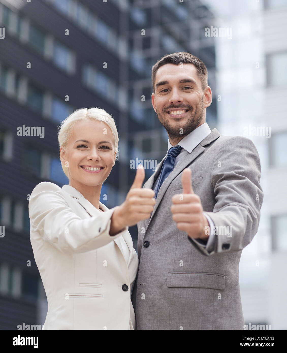 smiling businessmen showing thumbs up Stock Photo - Alamy