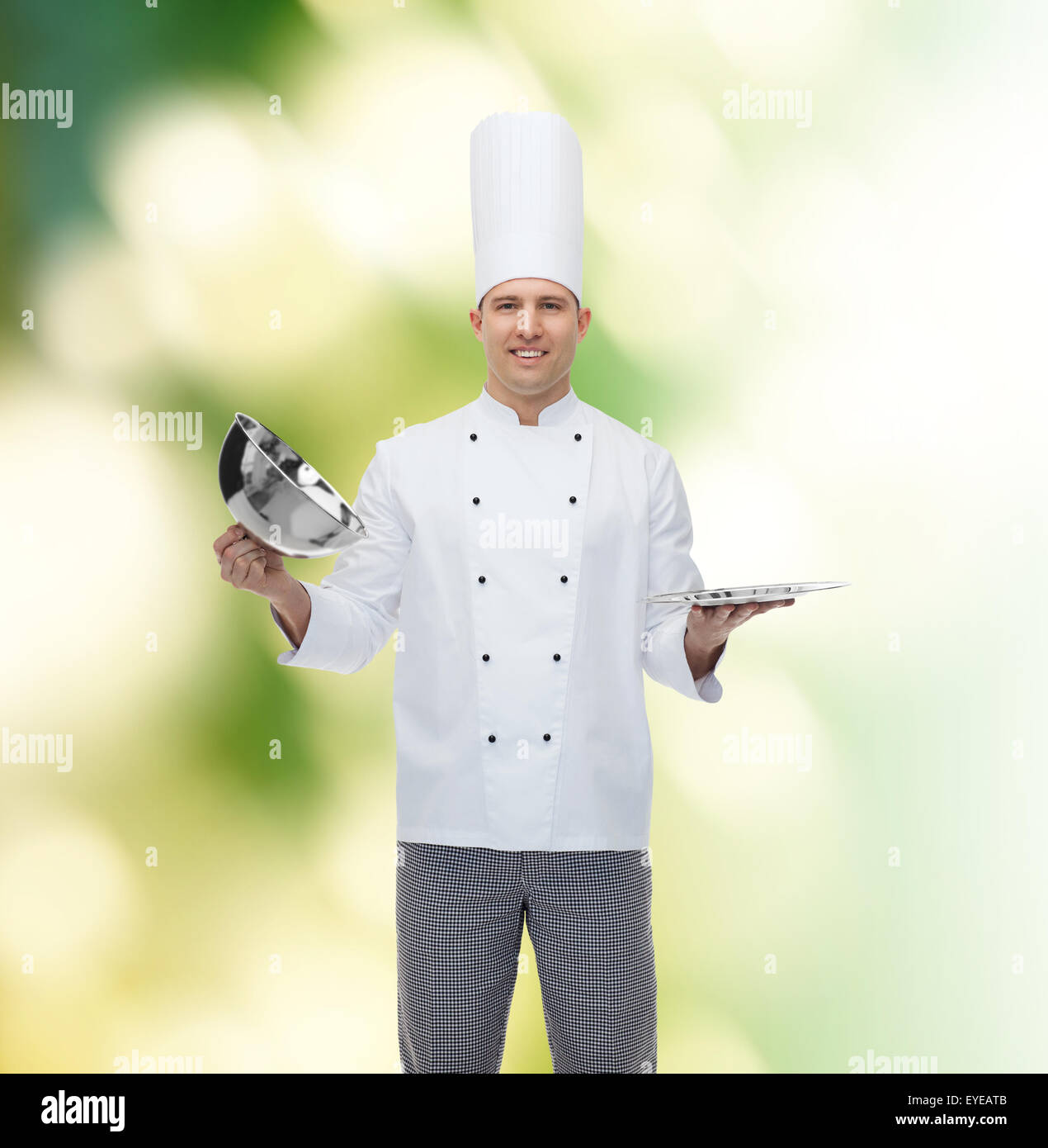 happy male chef cook opening cloche Stock Photo - Alamy