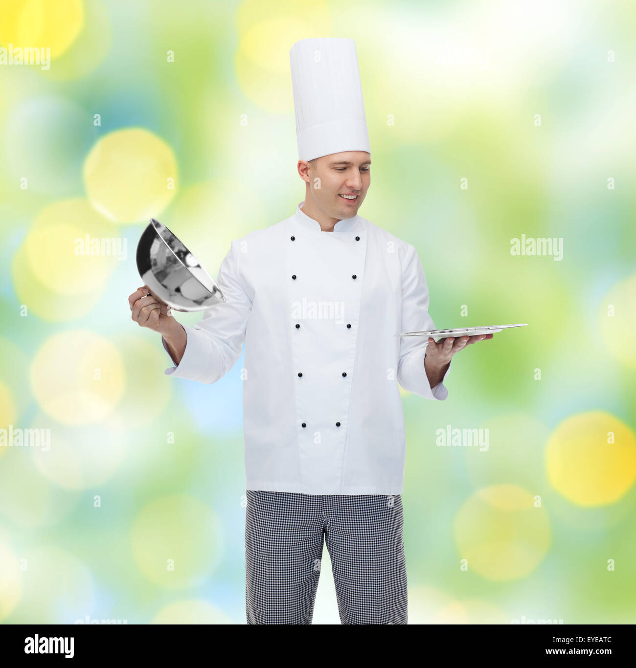happy male chef cook opening cloche Stock Photo - Alamy