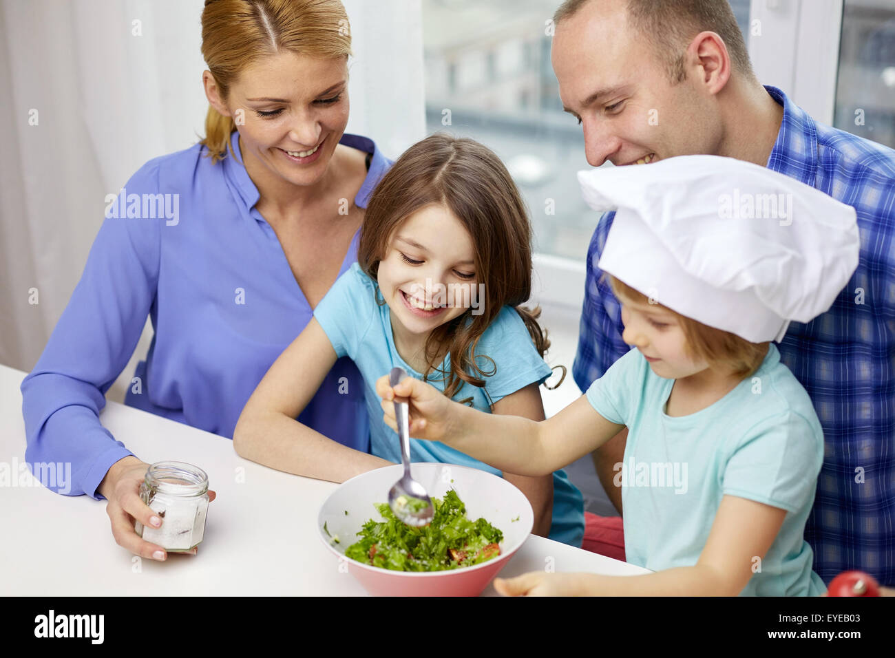 happy family with two kids cooking at home Stock Photo - Alamy