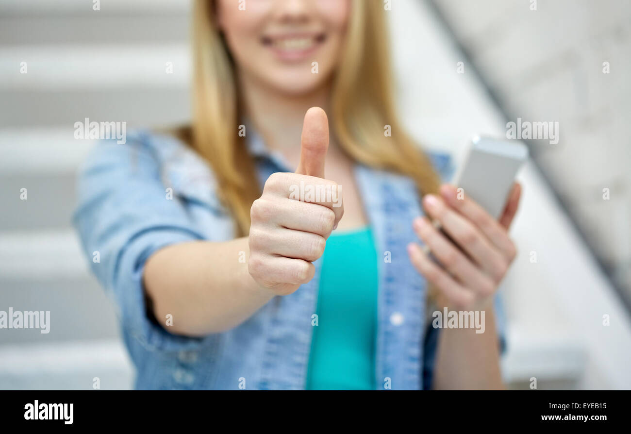 female with smartphone showing thumbs up Stock Photo - Alamy