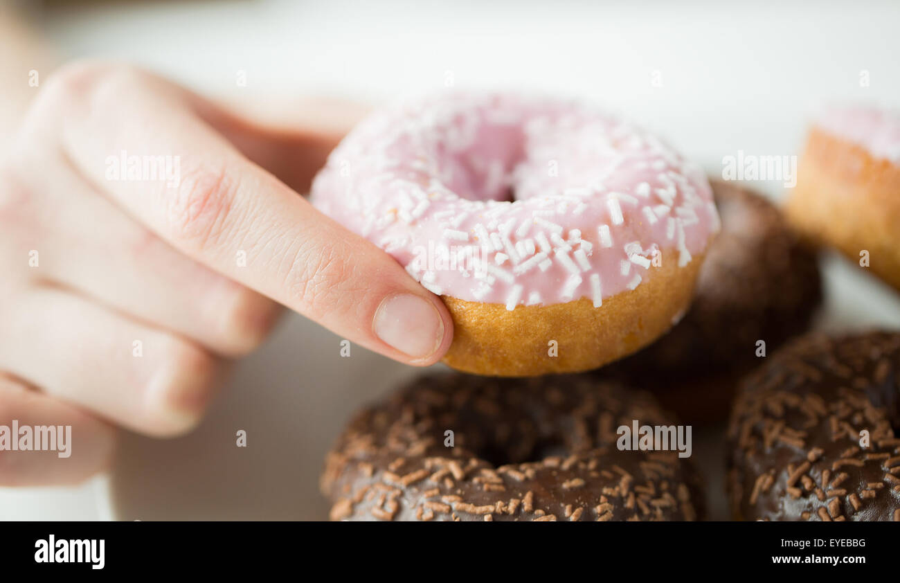 close up of hand holding glazed donut Stock Photo - Alamy