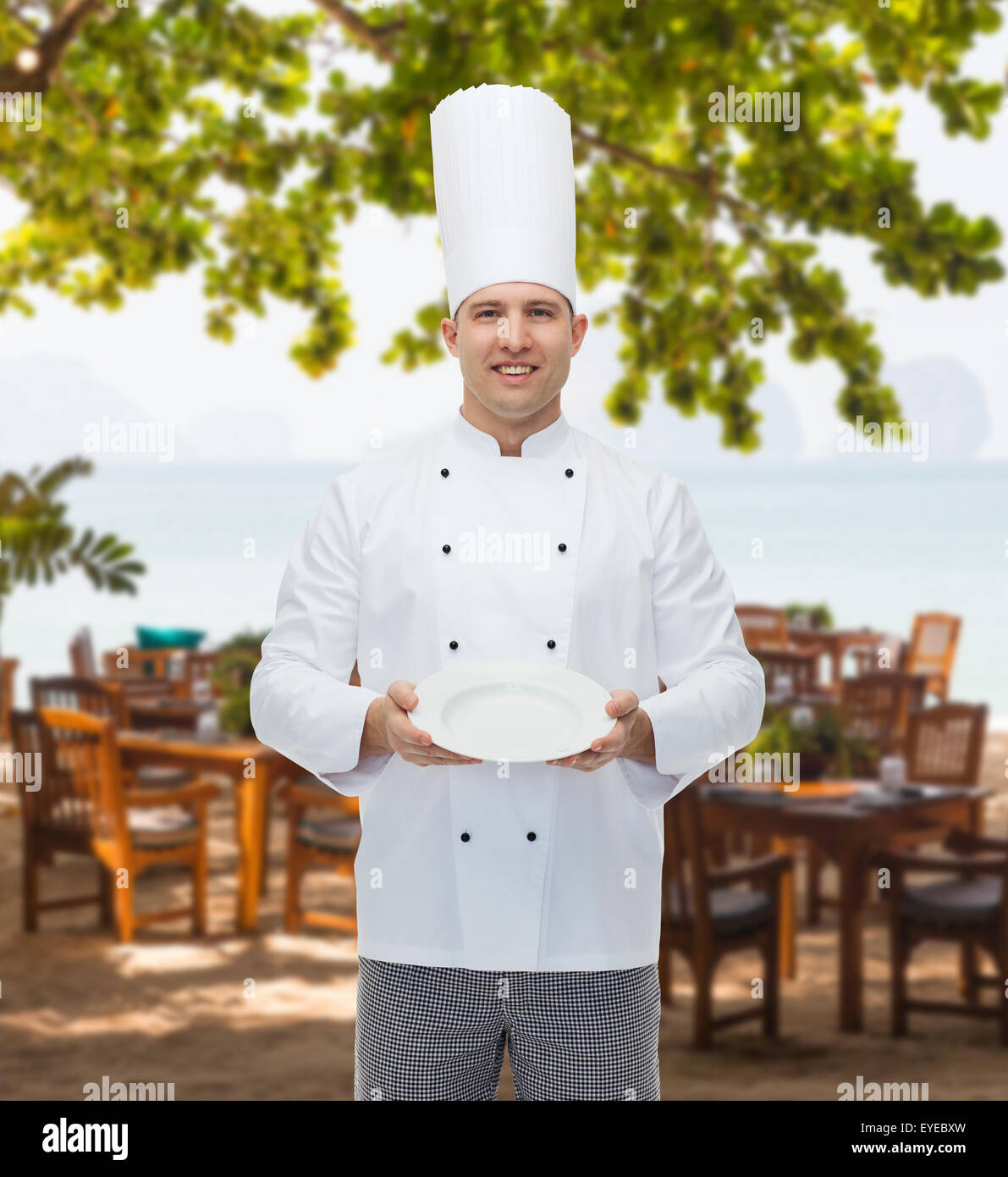 happy male chef cook showing empty plate Stock Photo - Alamy