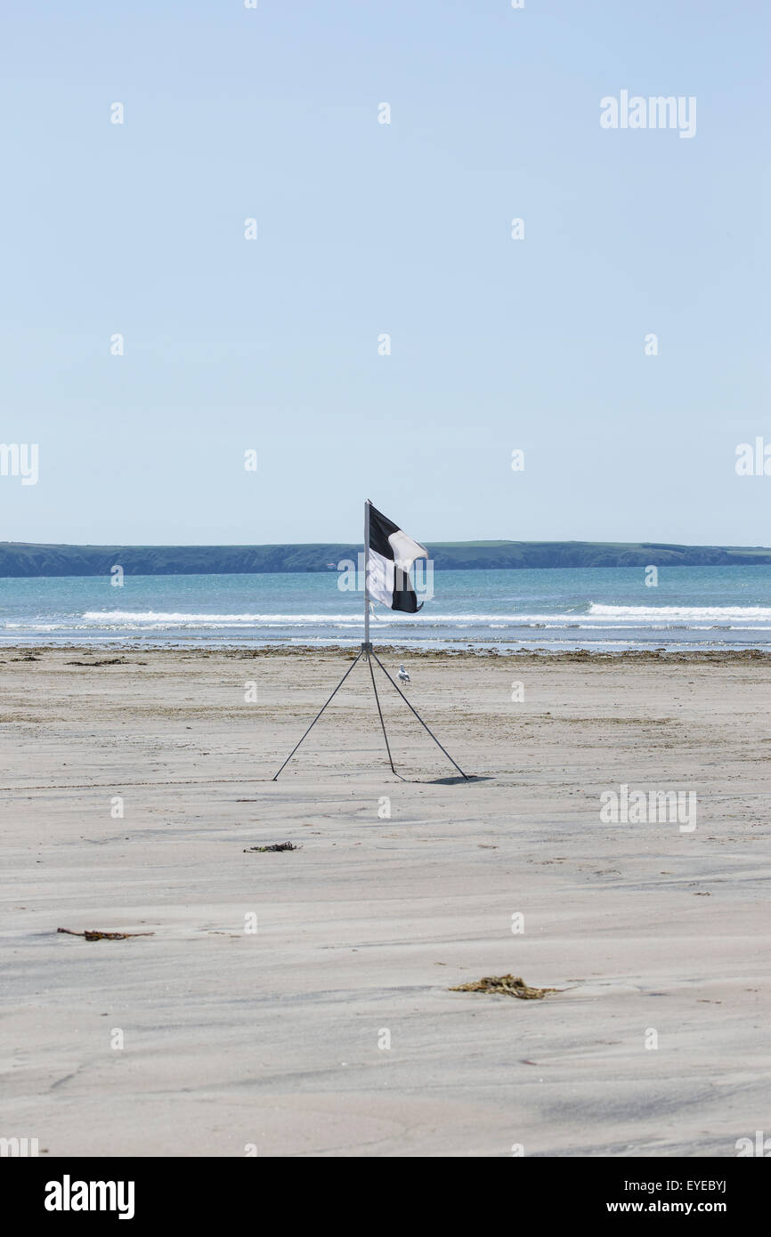 Black and white UK beach warning flag for sea safety Stock Photo - Alamy