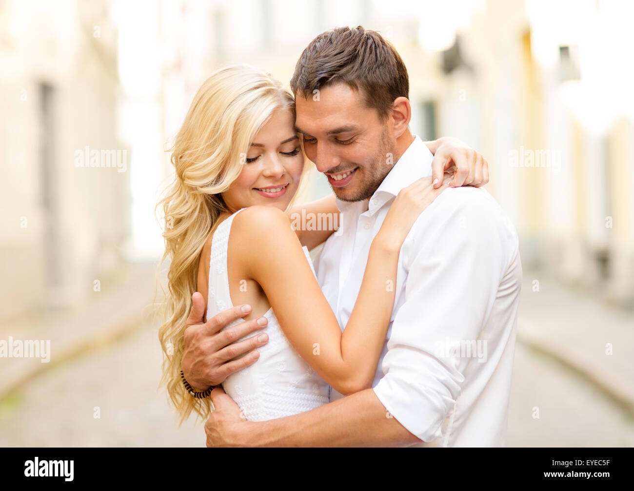 romantic happy couple hugging in the street Stock Photo - Alamy