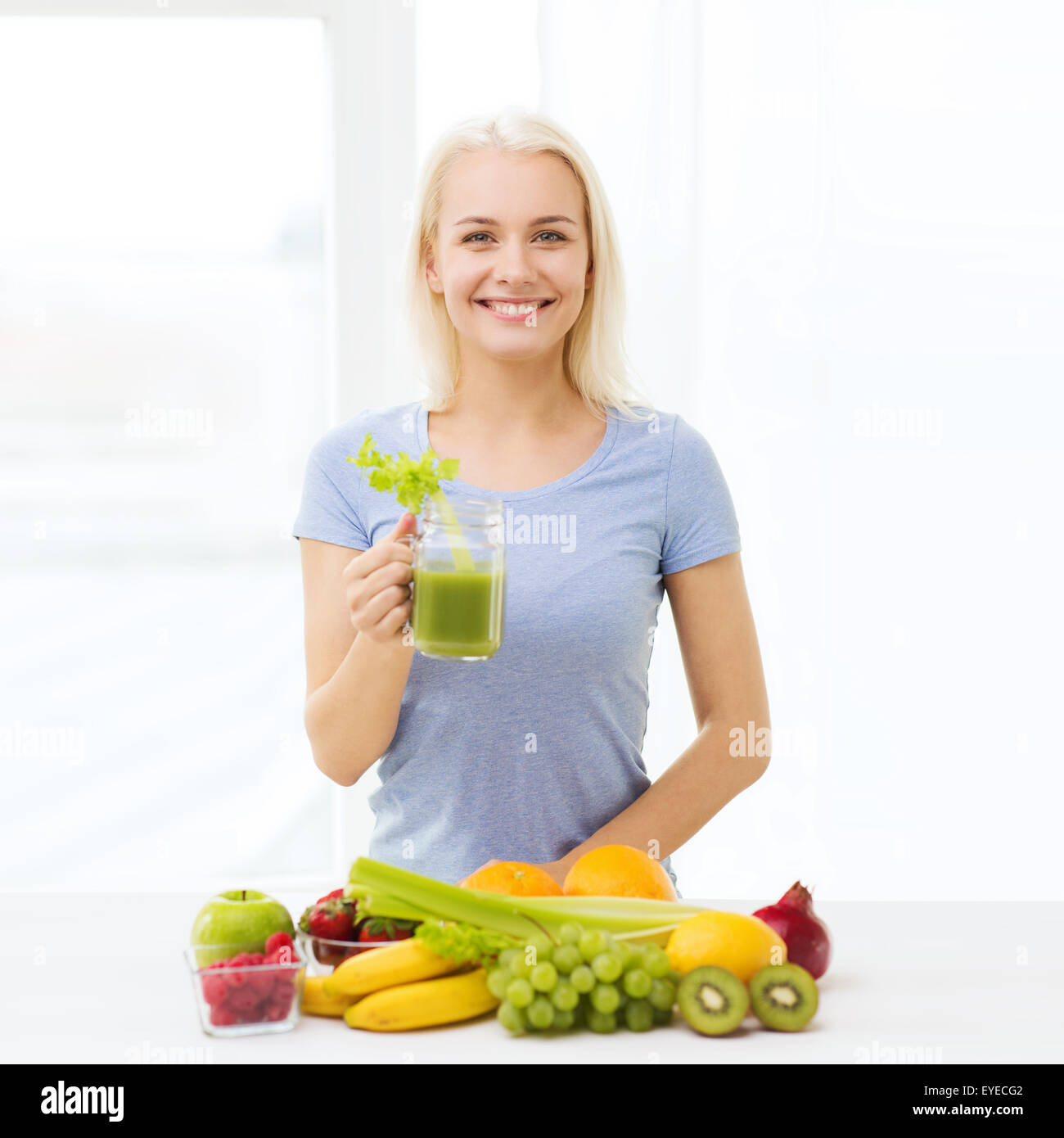 smiling woman drinking juice or shake at home Stock Photo - Alamy