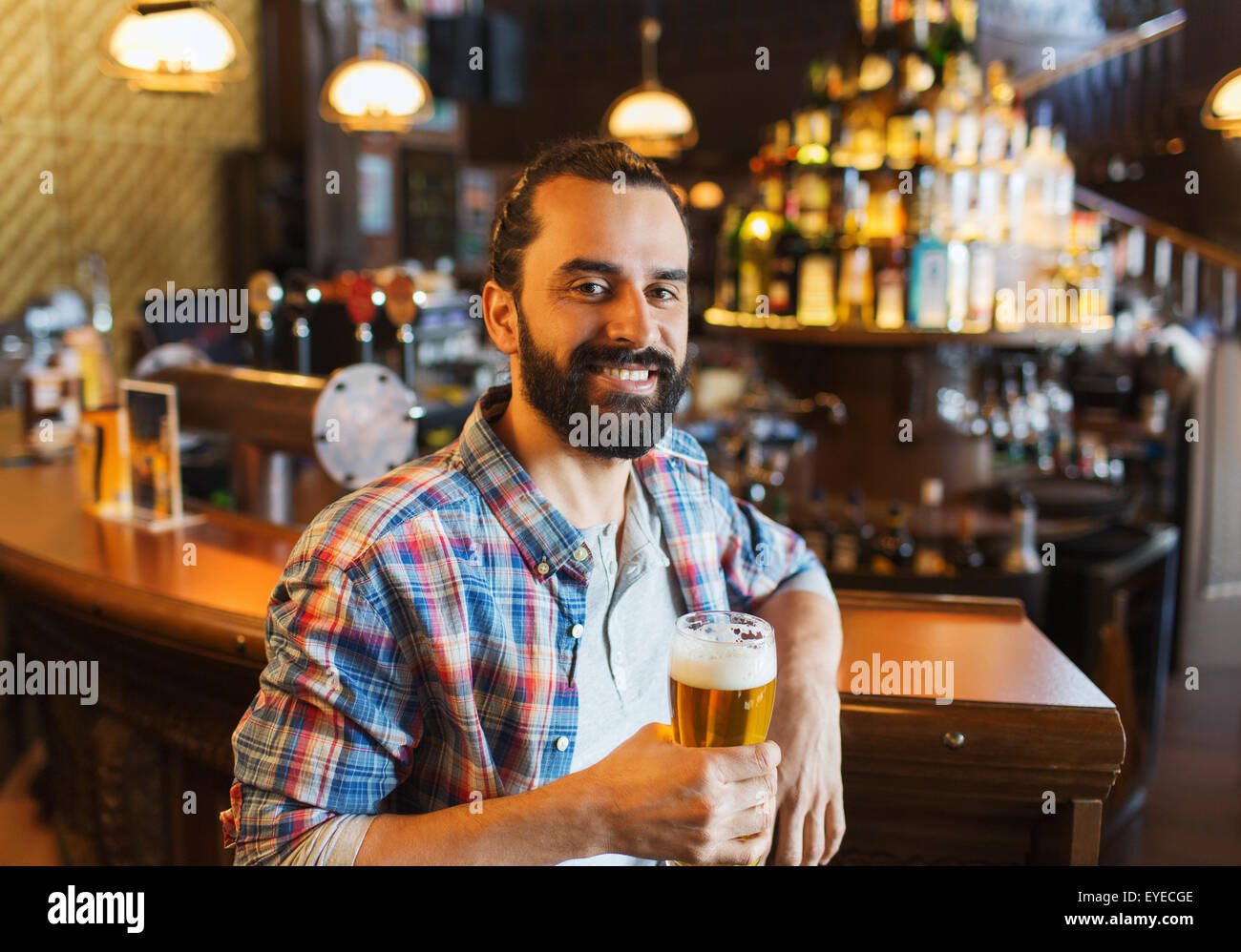 happy man drinking beer at bar or pub Stock Photo - Alamy