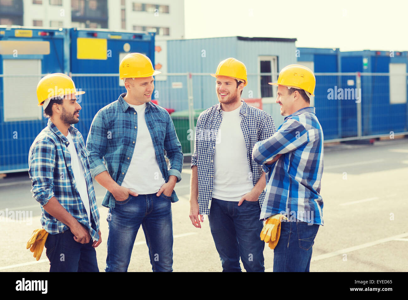group of smiling builders in hardhats outdoors Stock Photo - Alamy