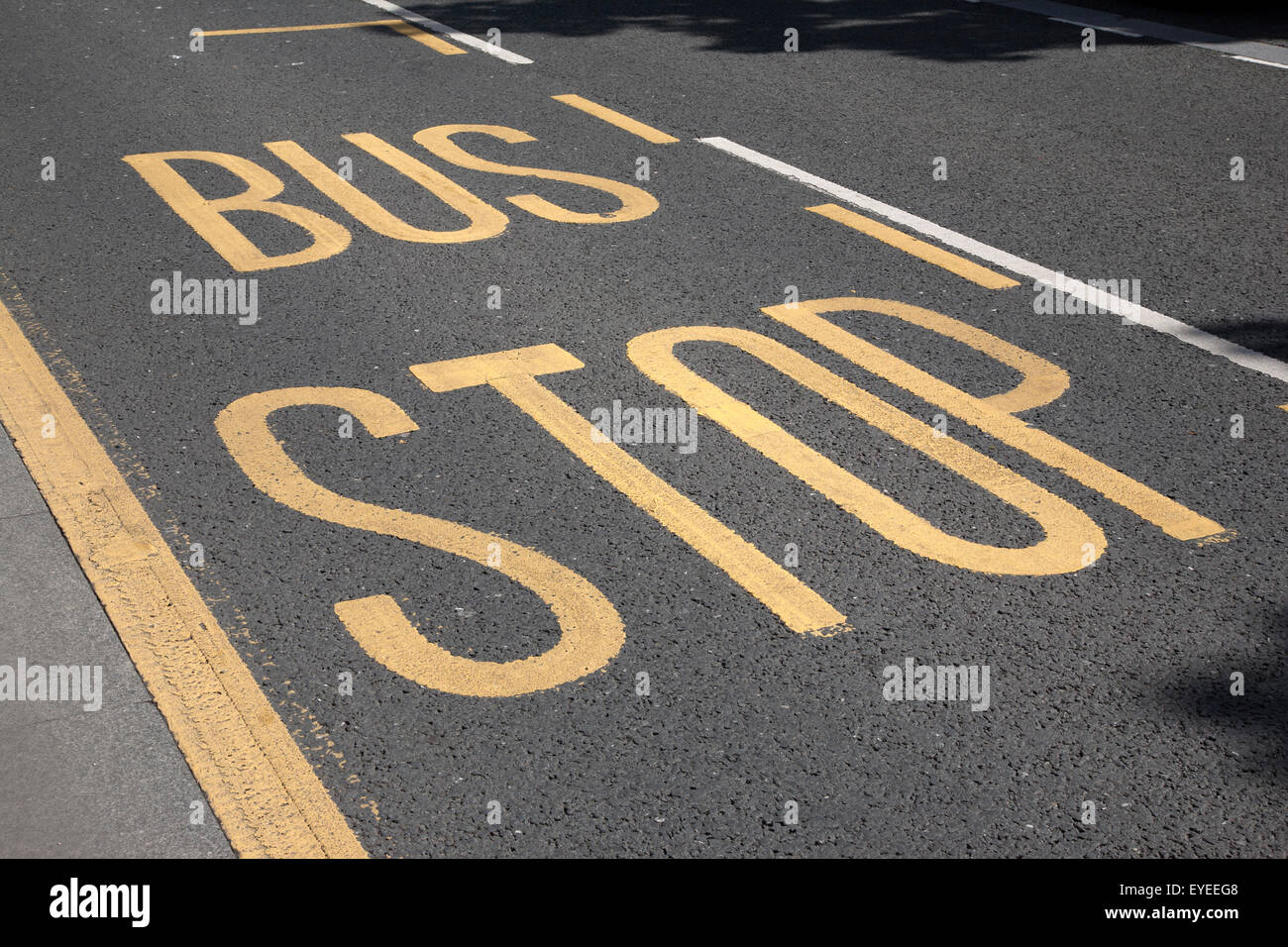 Bus Stop Sign Painted on Road Stock Photo - Alamy