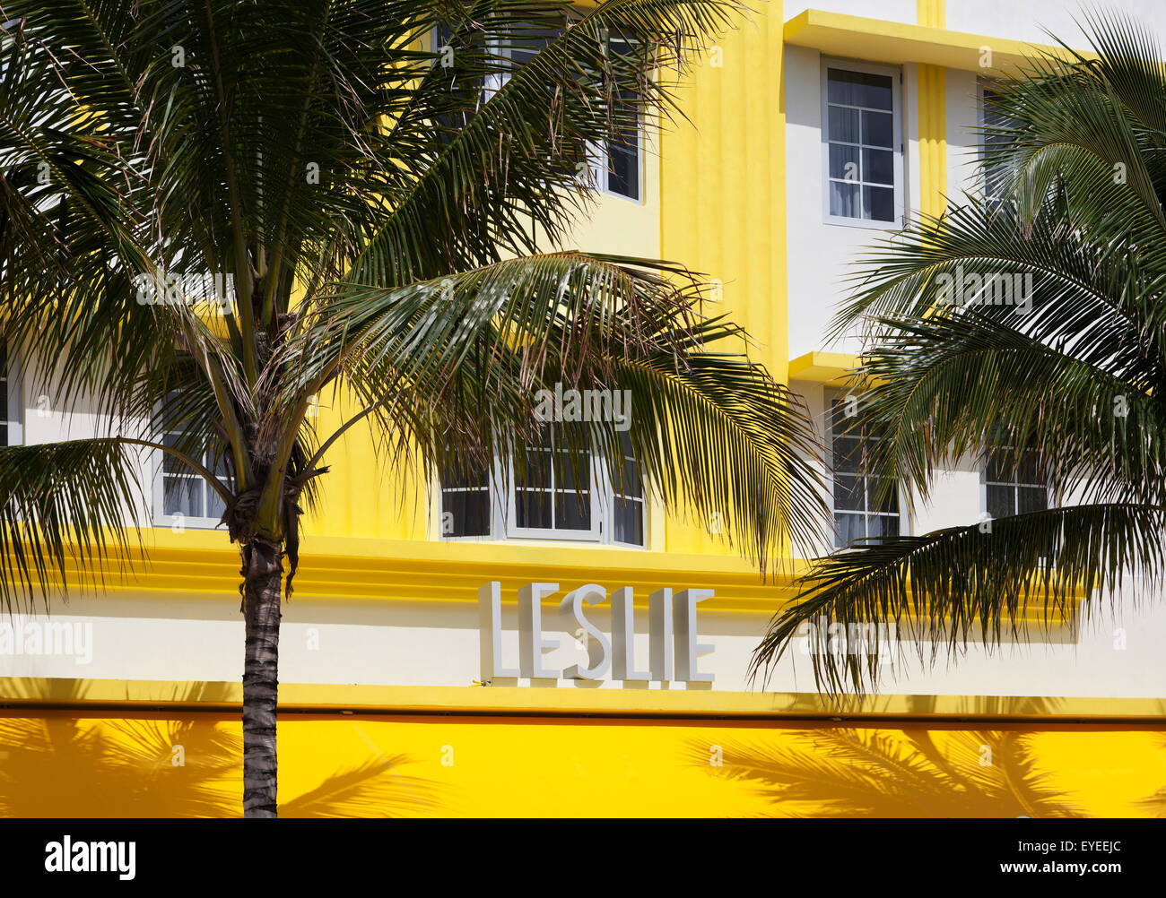 Bright yellow building with palm trees, South Beach; Miami, Florida ...