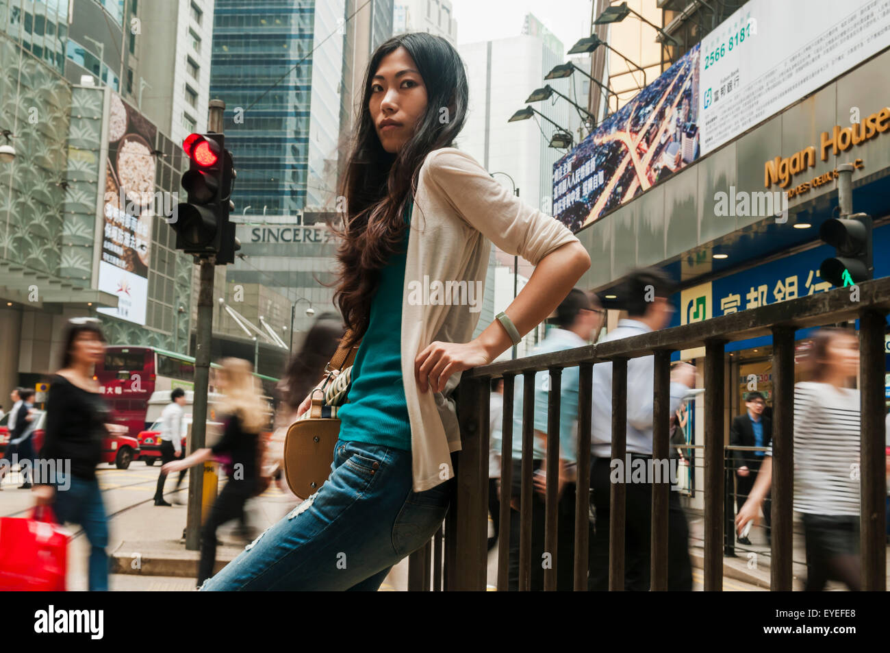 Chinese young woman in a busy, urban centre; Hong Kong, China Stock ...
