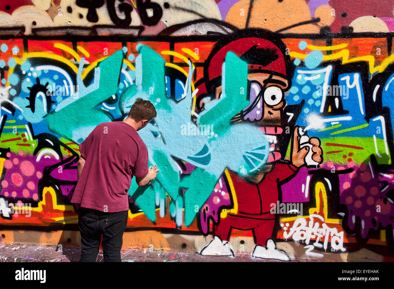 Graffiti artist in the Leake Street Graffiti tunnel; London, England ...