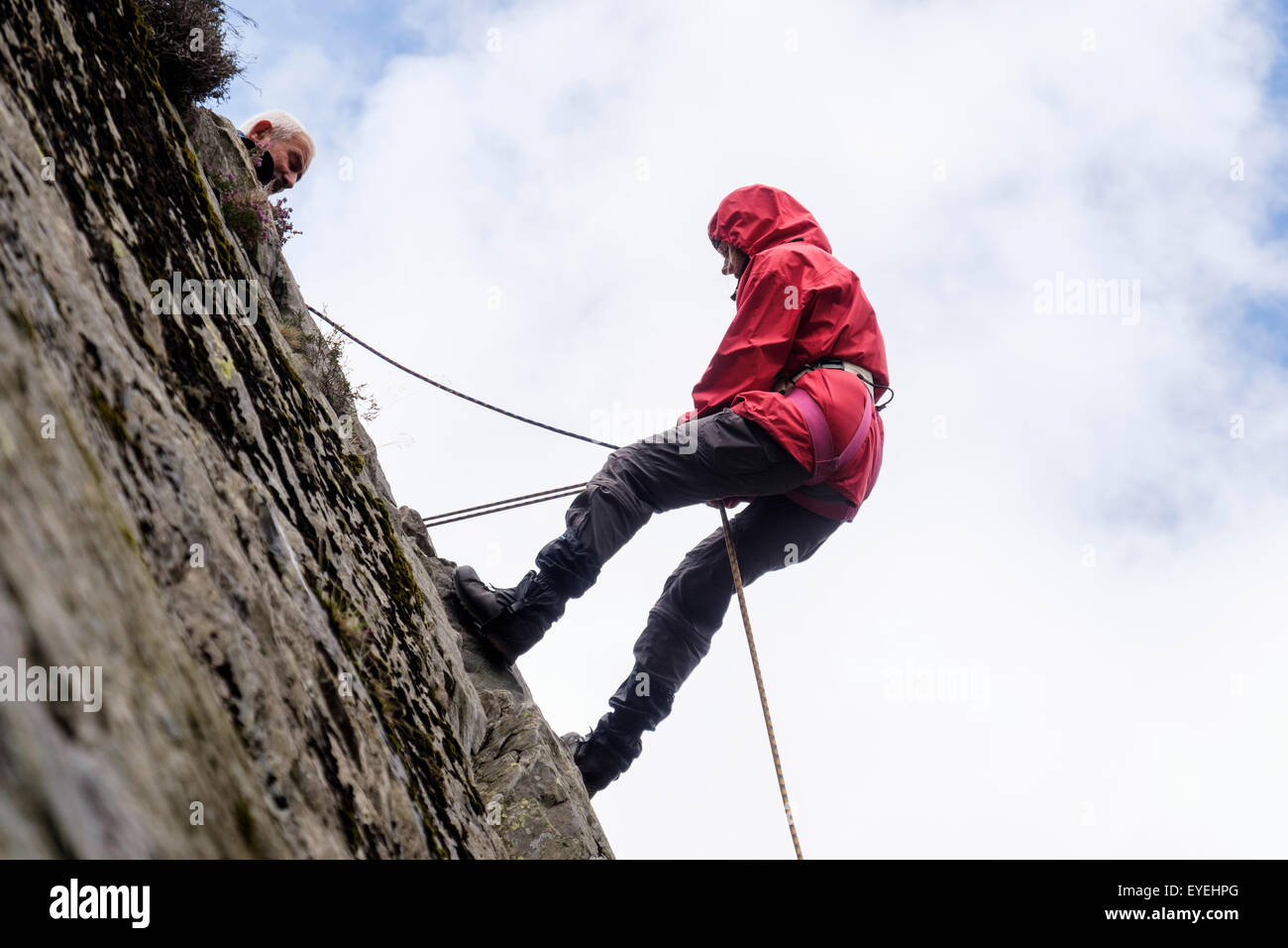 Female rock climber belayed from hi-res stock photography and images ...