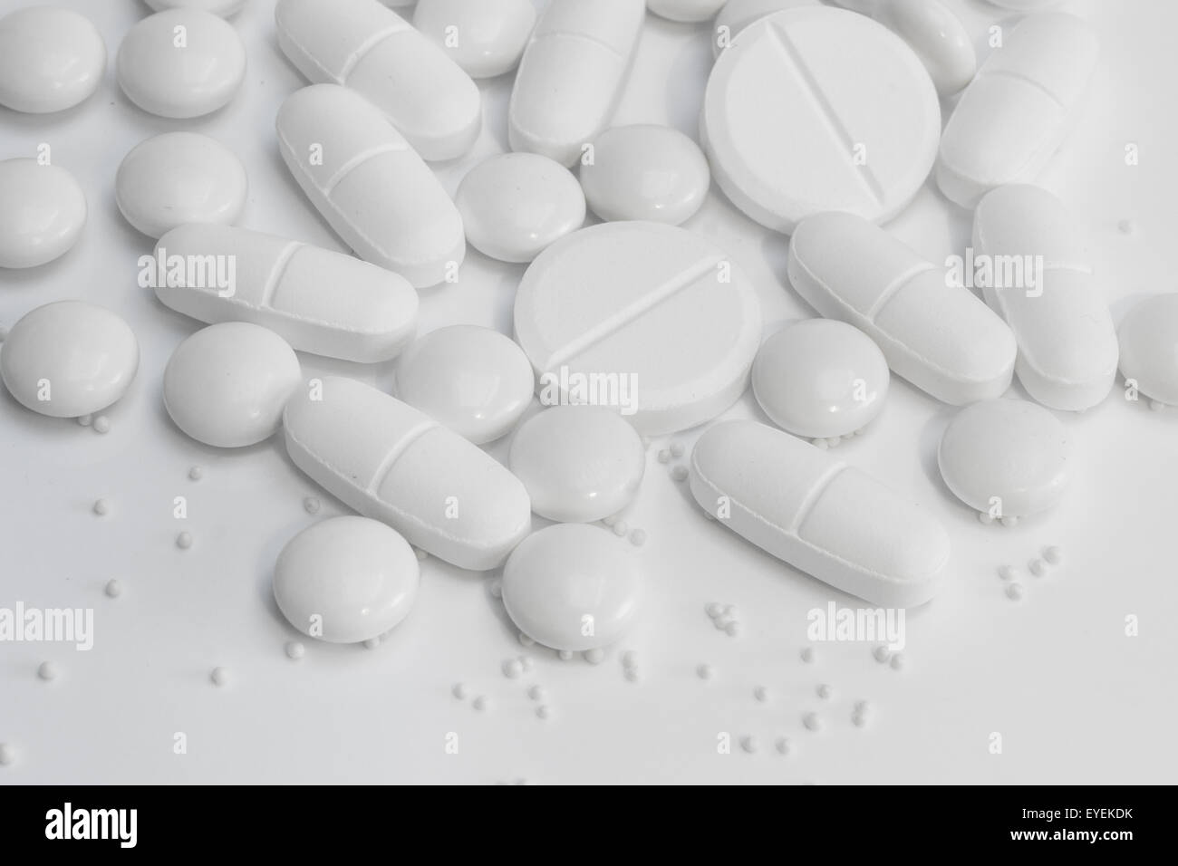 many white pills / tablets on white background Stock Photo - Alamy