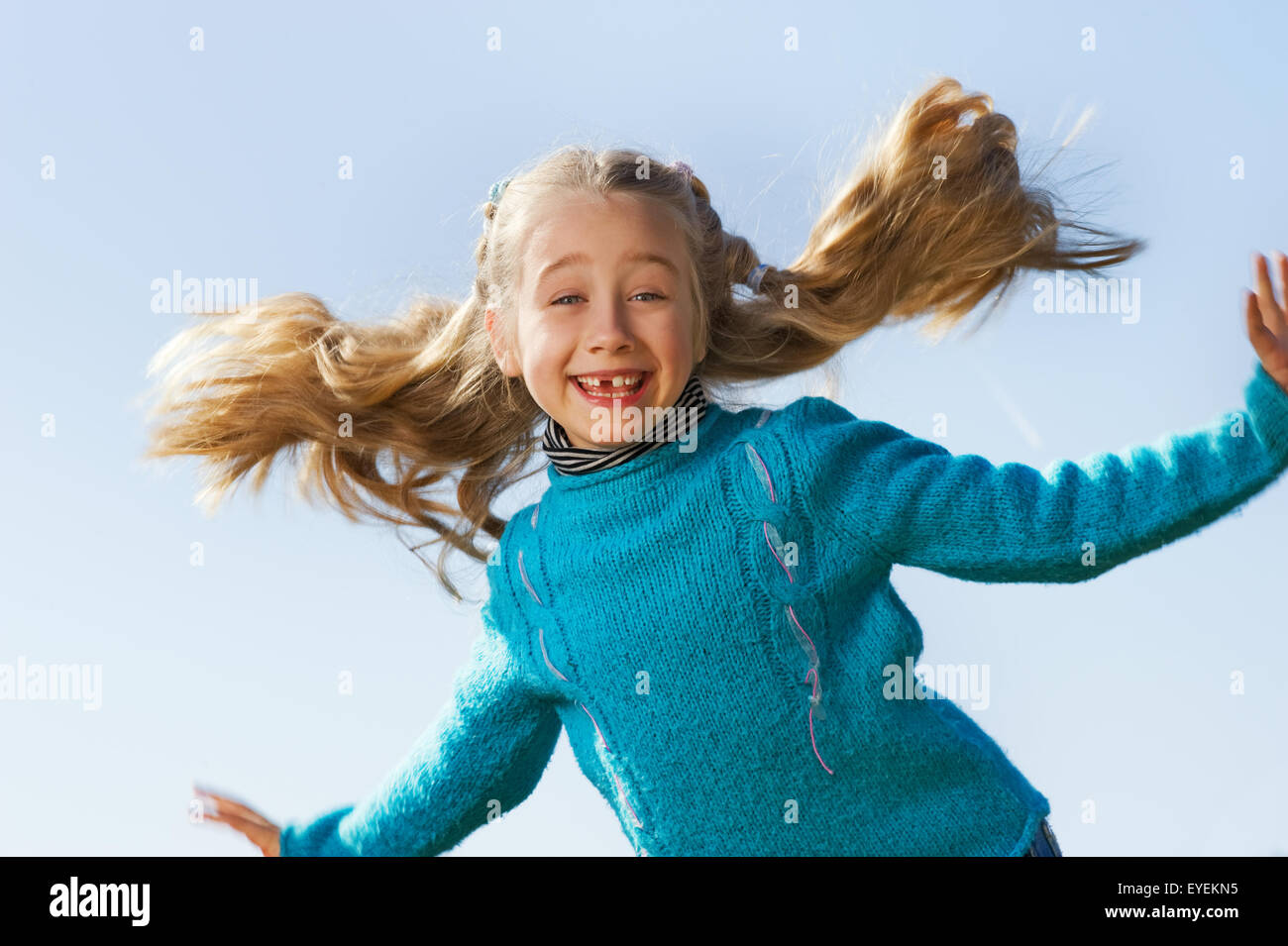 Little girl jumping outdoors Stock Photo - Alamy
