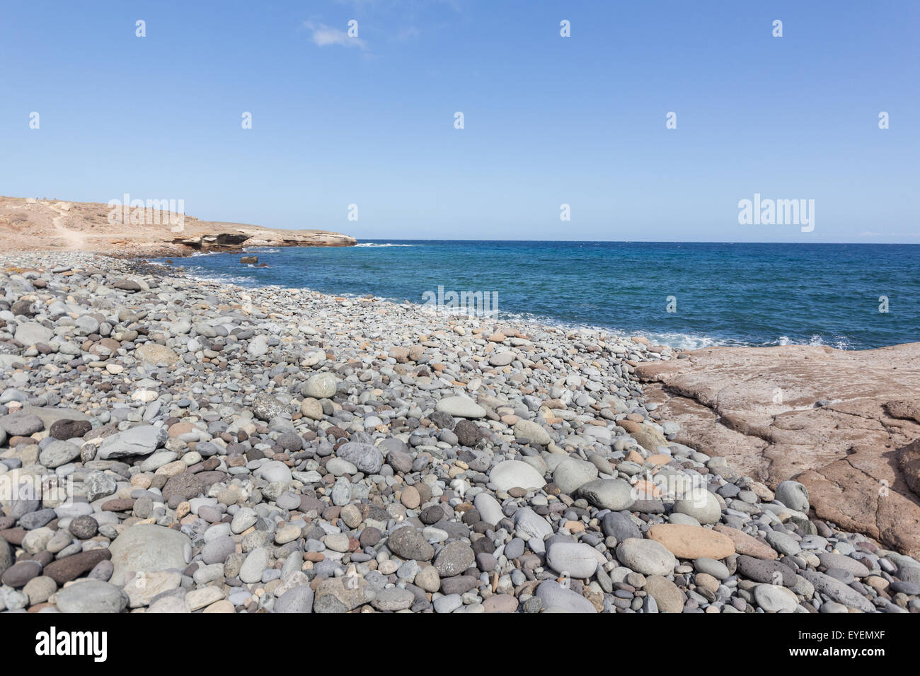 pebble stone beach, ocean and blue sky Stock Photo - Alamy