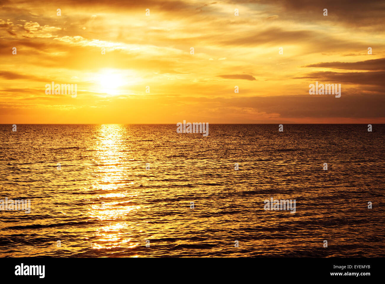 sunset at the sea with beautiful water and clouds Stock Photo - Alamy