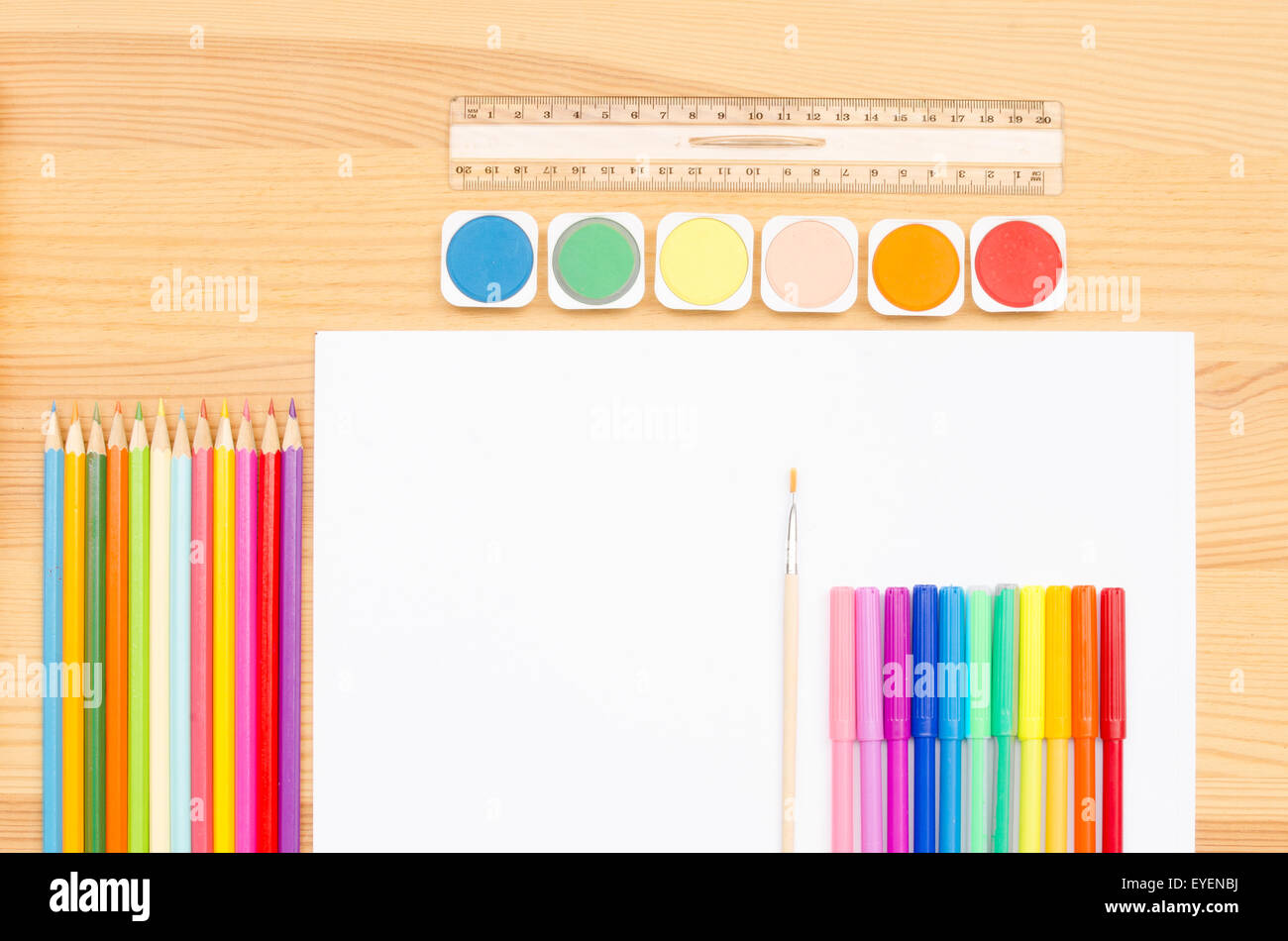 group color school supplies on wooden background Stock Photo - Alamy