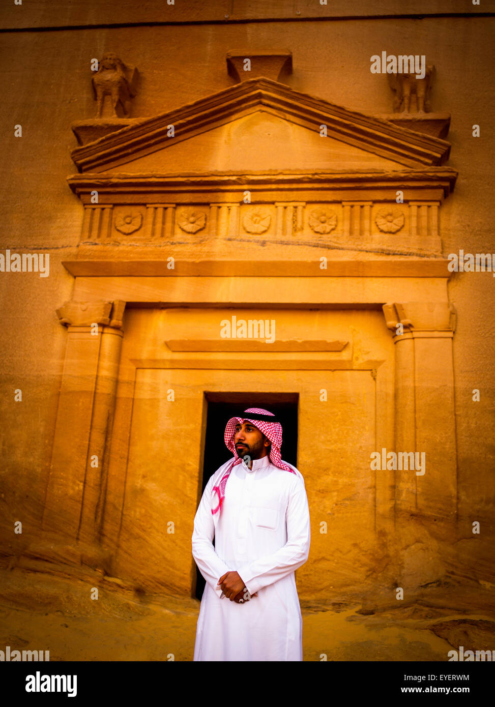 Saudi man standing at pre-Islamic archaeological site; Madain Saleh ...