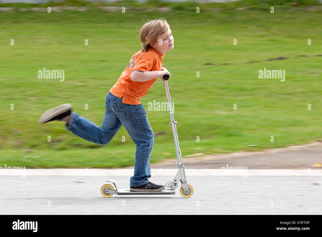 young boy on a scooter Stock Photo - Alamy