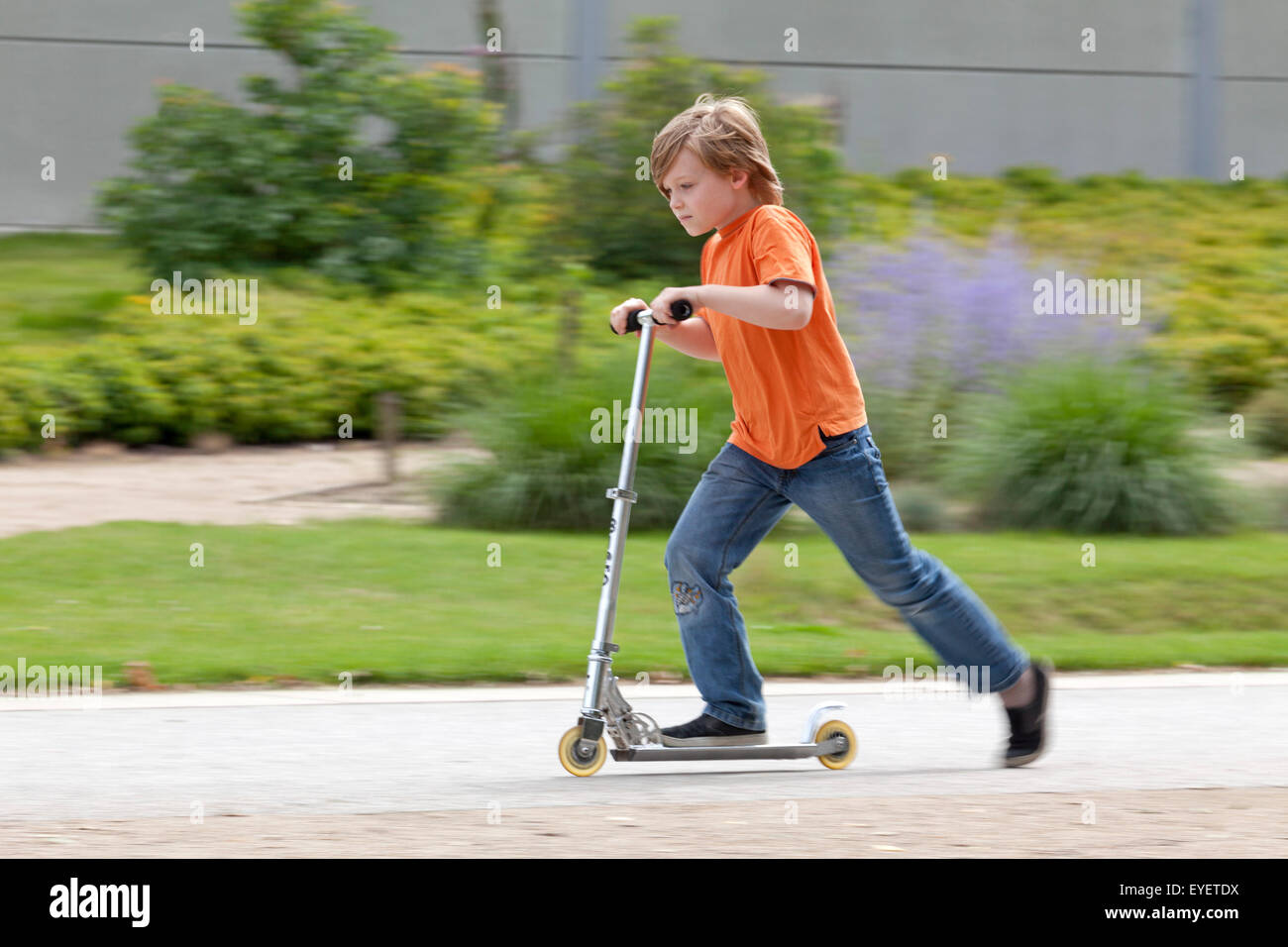 young boy on a scooter Stock Photo - Alamy