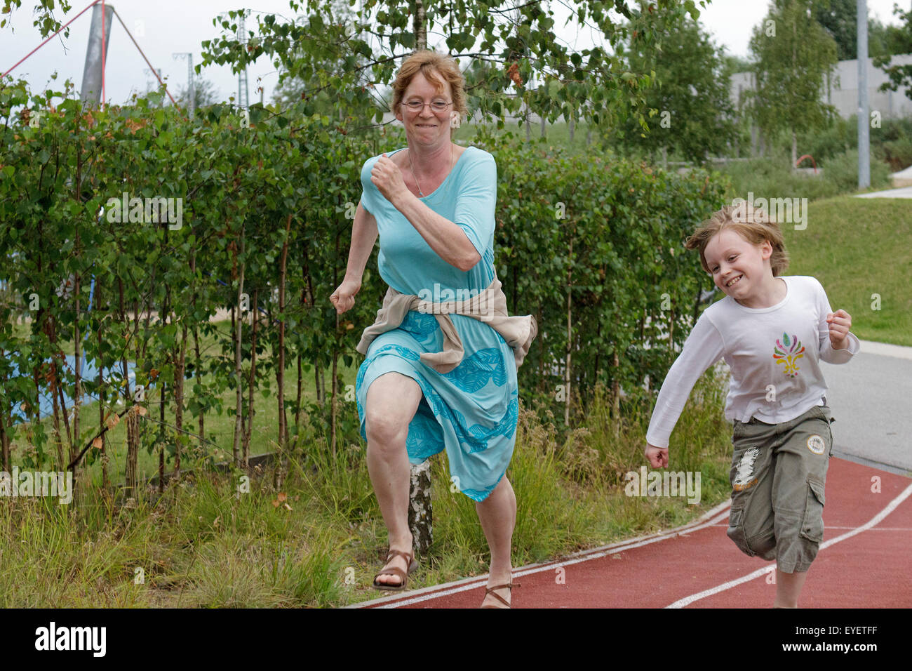 mother and son having a race Stock Photo - Alamy