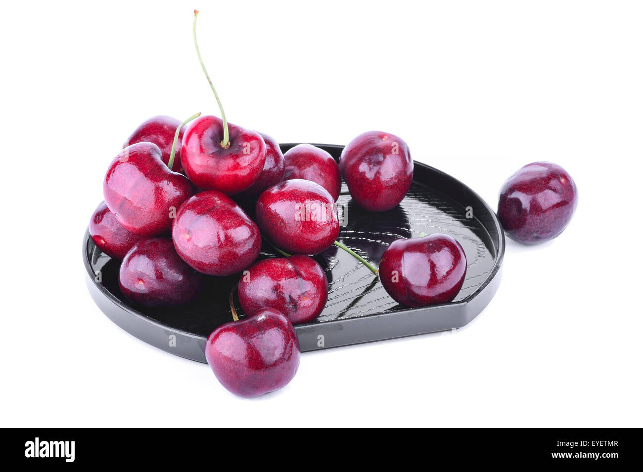 Ripe purple cherry on plate, isolated on white background Stock Photo ...