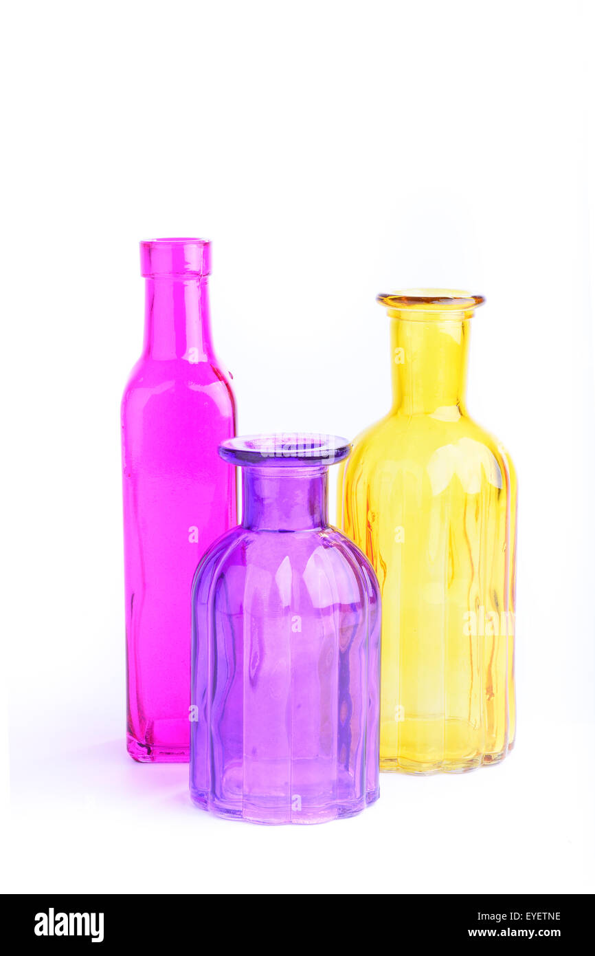 Three colorful bottles, isolated on white background Stock Photo - Alamy