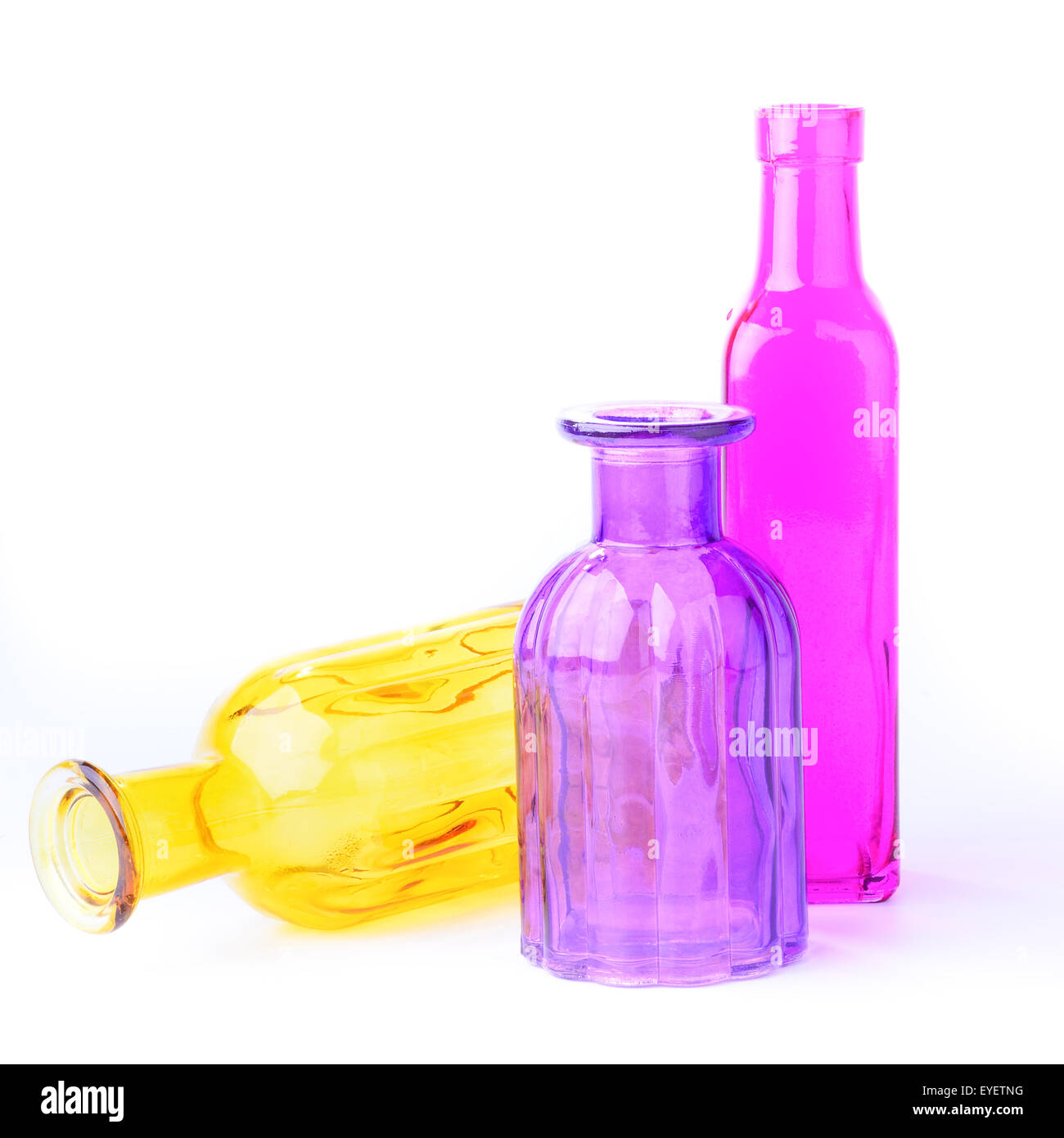 Three colorful bottles, isolated on white background Stock Photo - Alamy