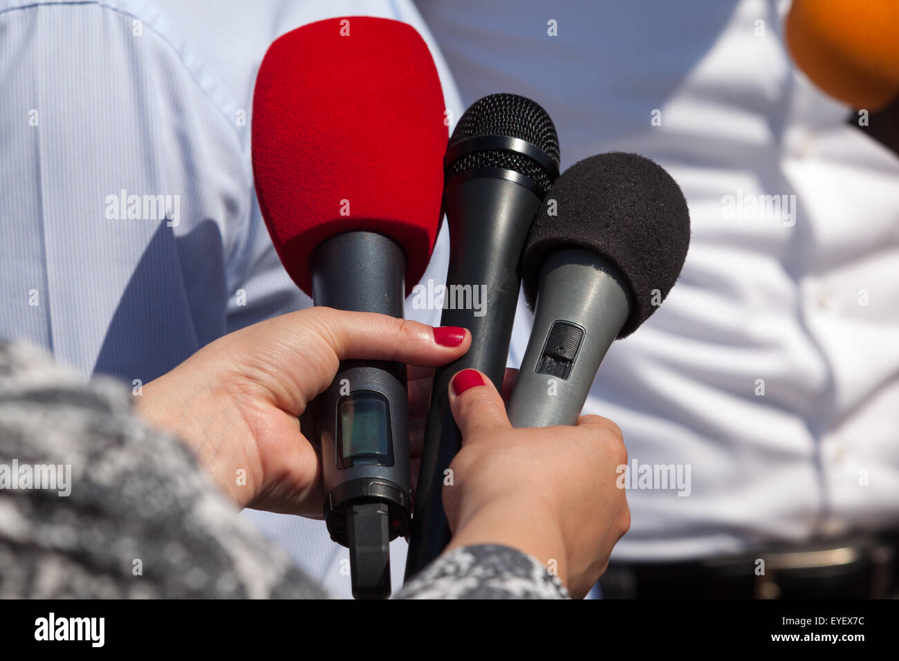 Broadcast journalism. Reporters taking interview at news conference ...